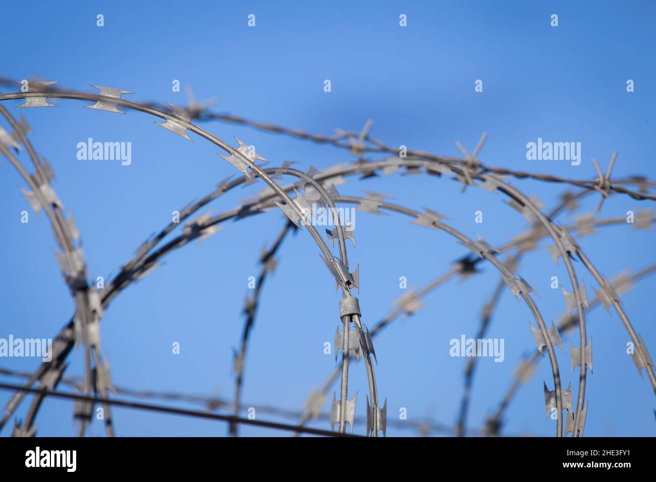 Closeup focus view of NATO barb wire with sharp and dangerous razor ...