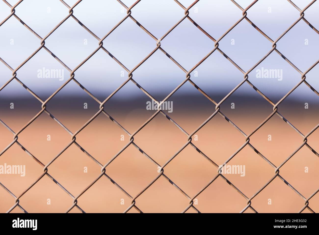 Chicken wire pattern closeup with brown background Stock Photo - Alamy