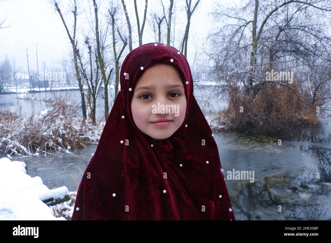 Srinagar, Jammu and Kashmir. 8th January, 2022. A Kashmiri girl looks ...