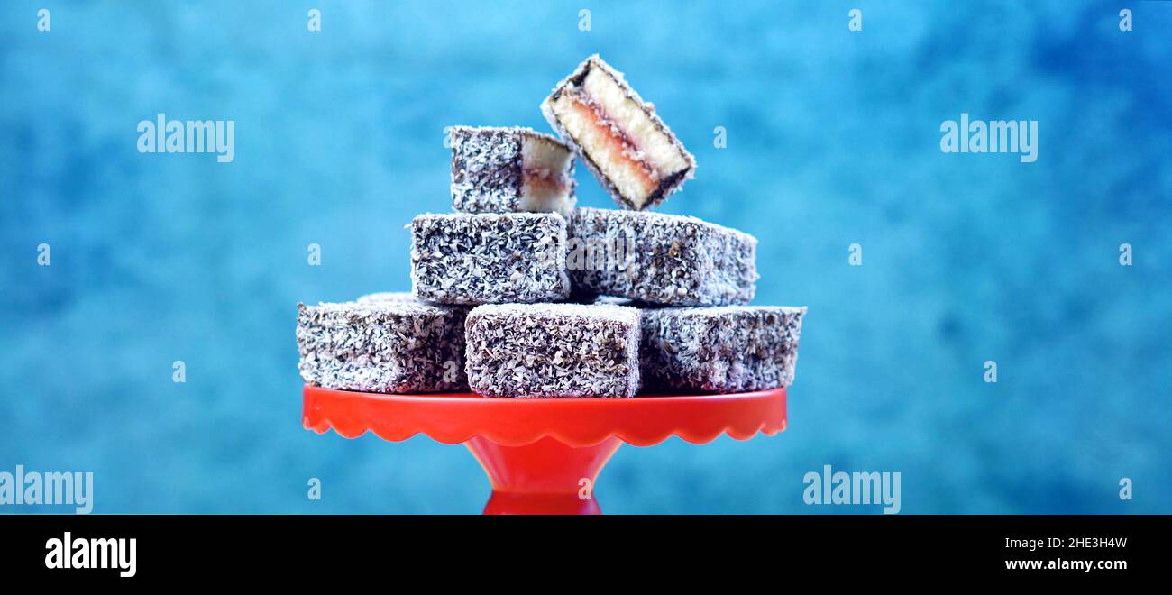 Iconic traditional Australian party food, Lamington cake, on a red ...