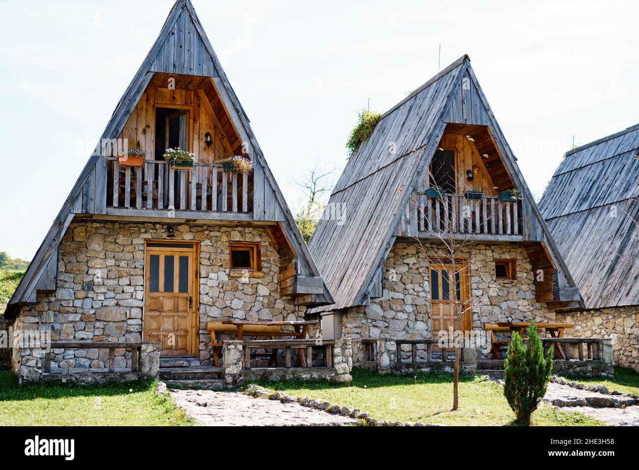 Triangular stone houses with wooden roofs and terraces. Montenegro ...