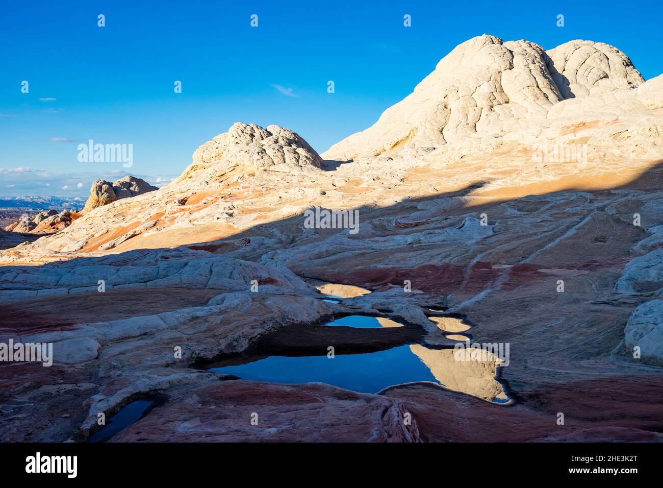 A rare occurrence, red and white rock formations reflected in pool of ...