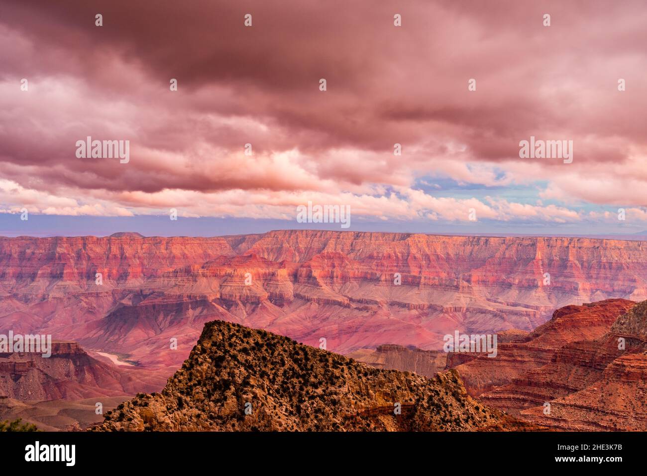 Grand Canyon with Colorado River in distance clouds overhead reflecting ...