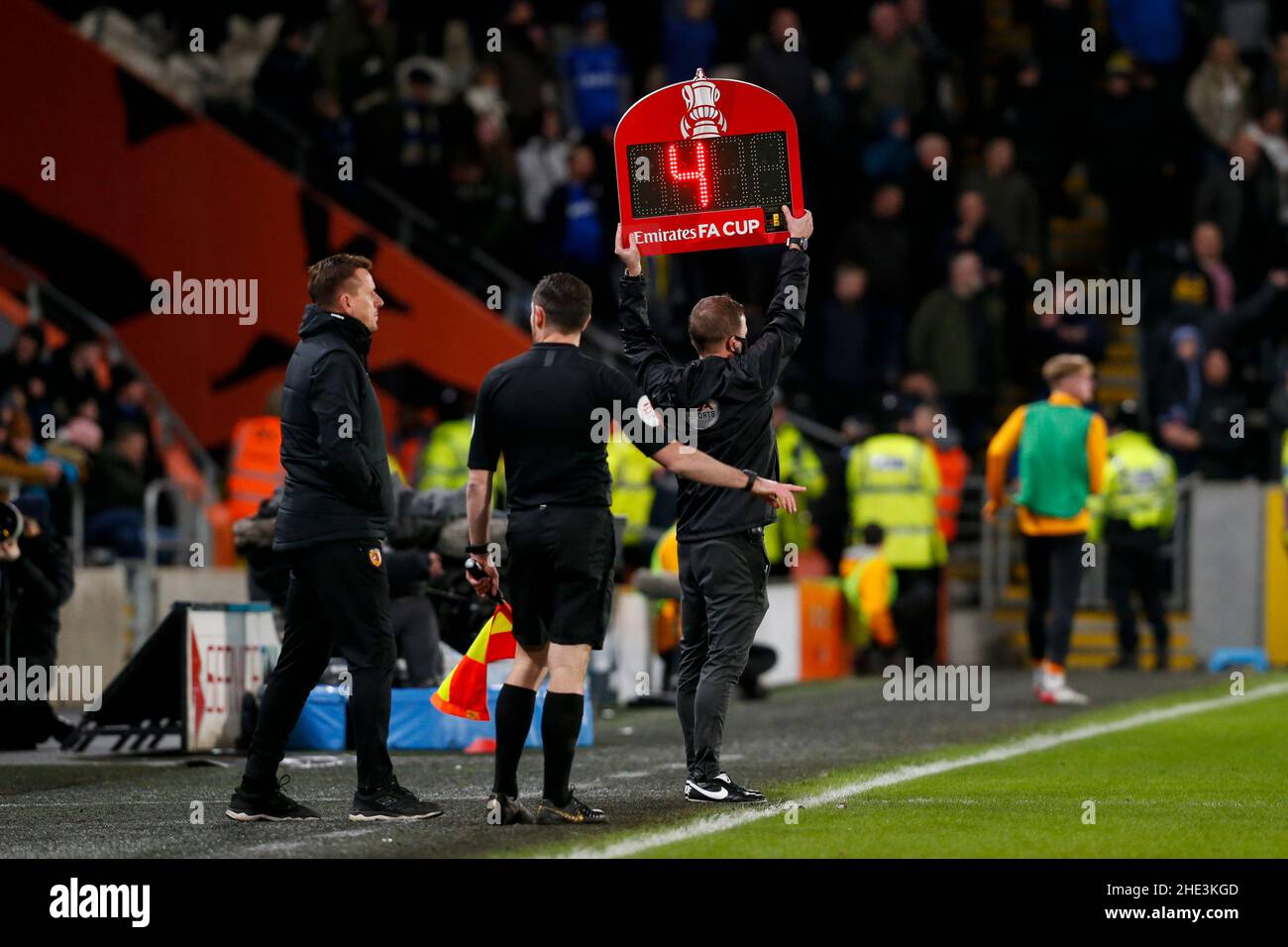 The fourth official holds up the Emirates FA Cup branded digital board ...