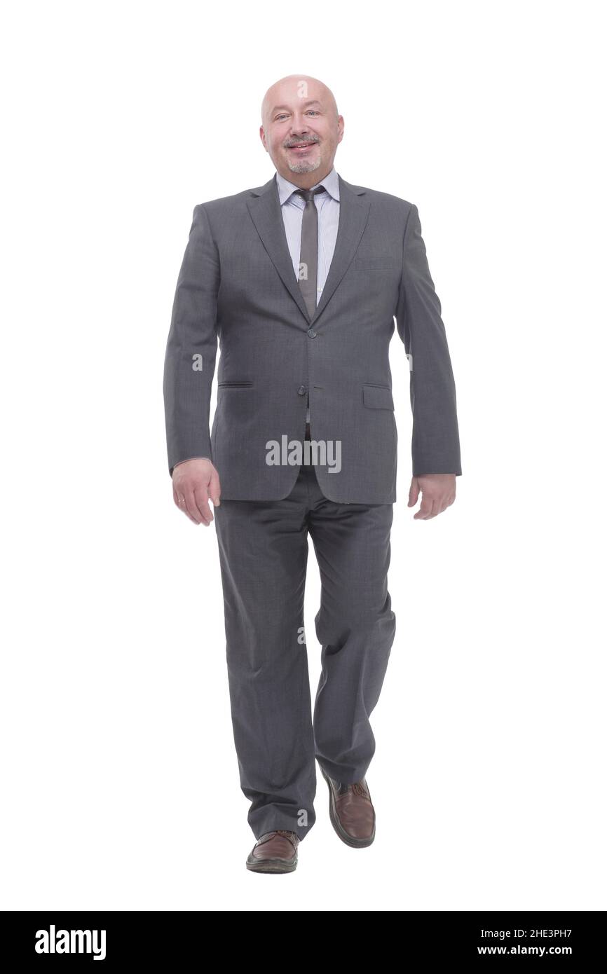 Mature business man striding forward .isolated on a white background ...