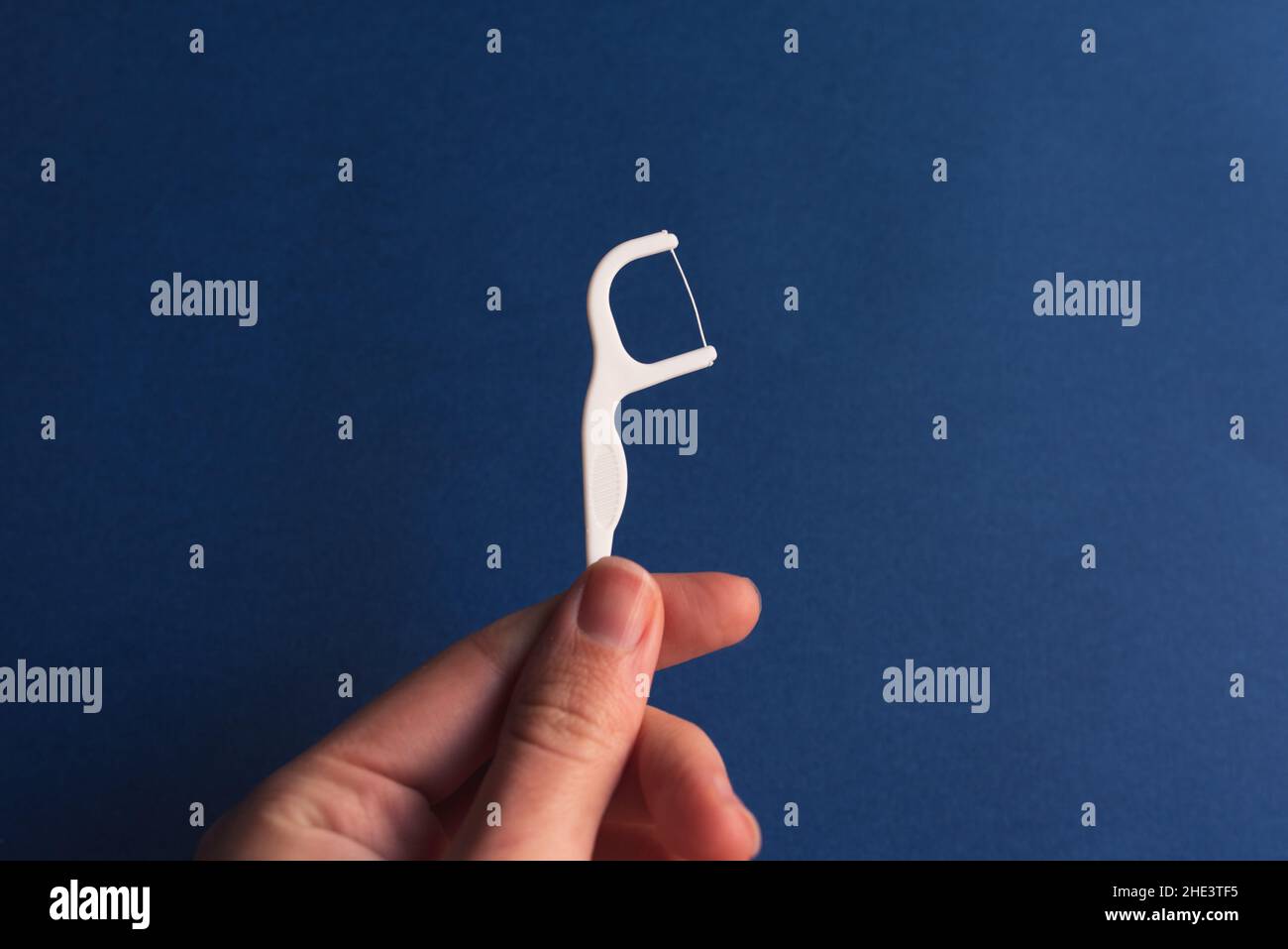 Hand holding inter dental arch flossing teeth. Oral health Stock Photo ...