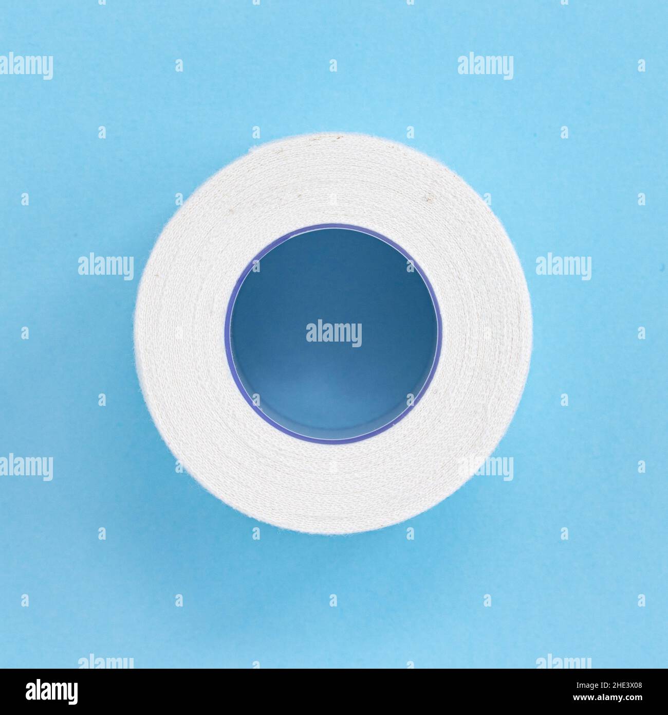 white roll band aid strip isolated on blue background, reel of adhesive ...