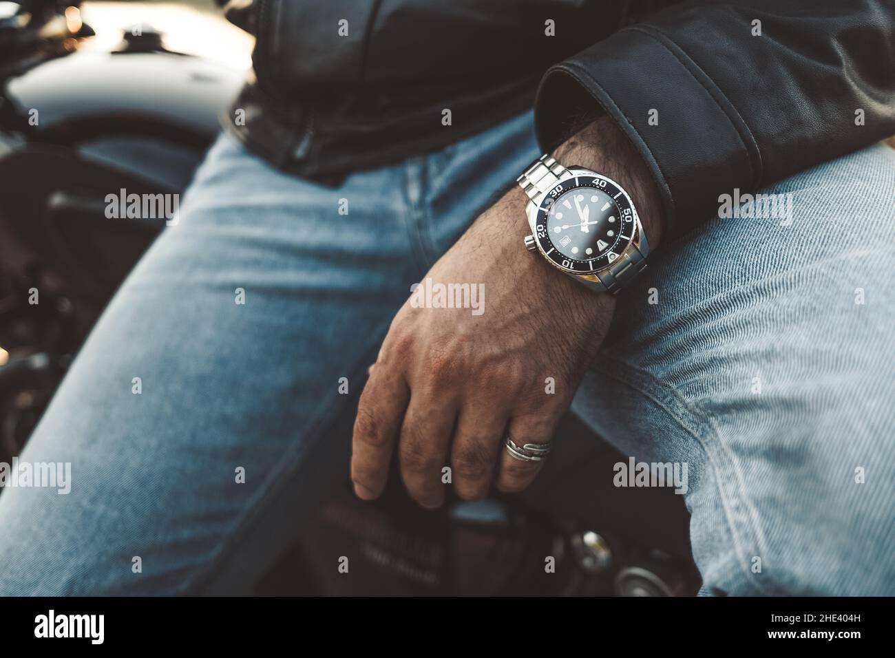Male wrists, expensive watch close-up. Hands of young man sitting on ...