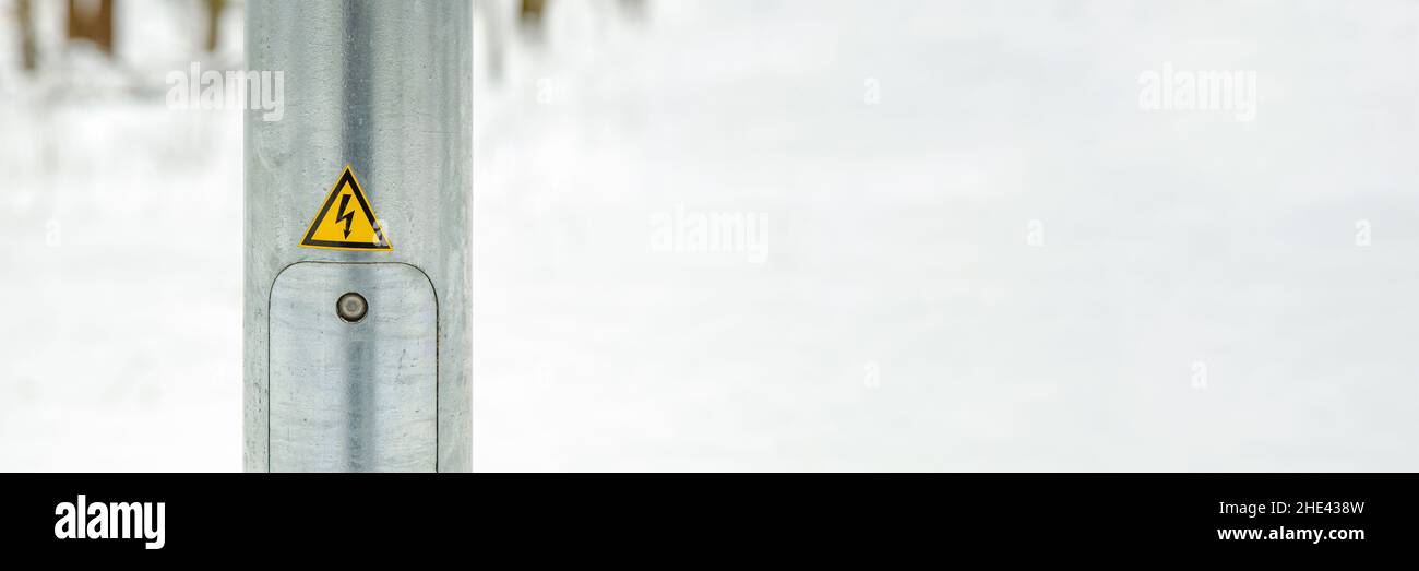 Lighting pole in the city. Electricity service door. Pasted yellow ...