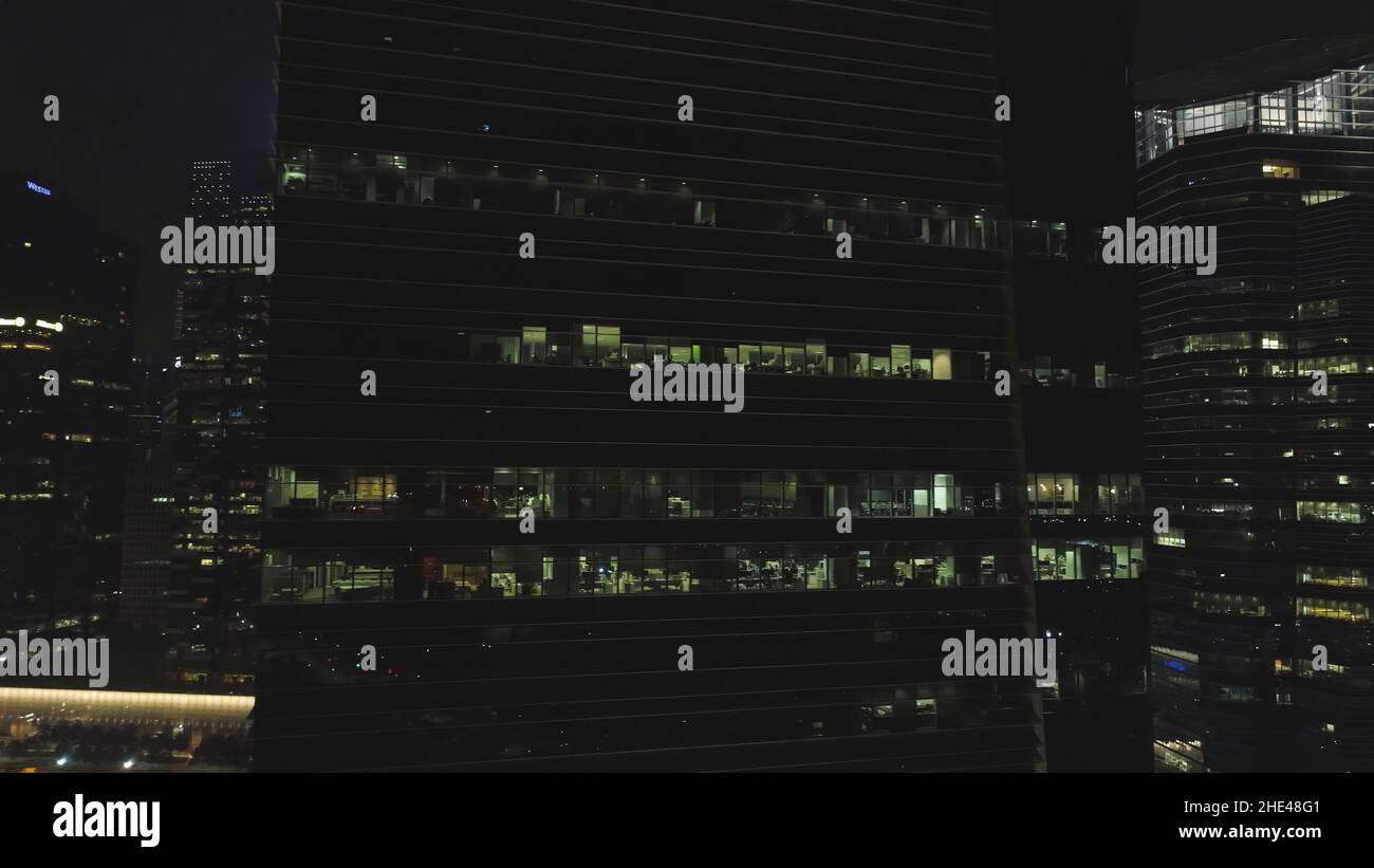 Frontal view of the night facade of building with a lot of lighted ...