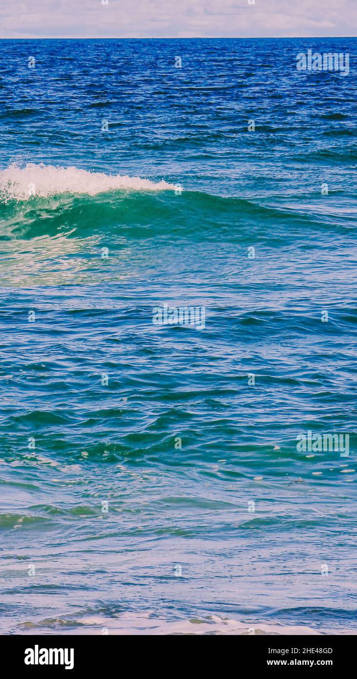 Vertical shot of soft ocean waves with foam Stock Photo - Alamy
