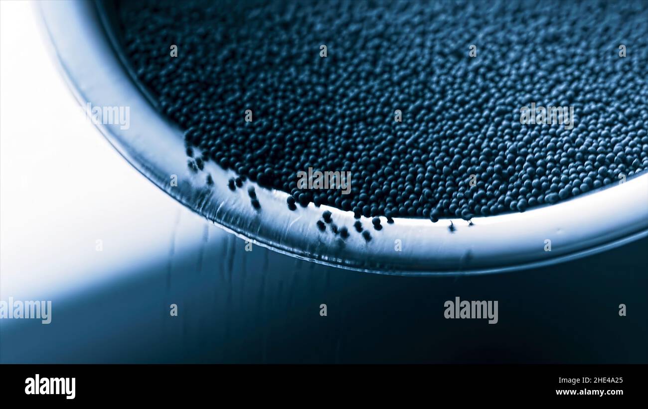 Analysis of gravel samples in laboratory. Close up of small black ...