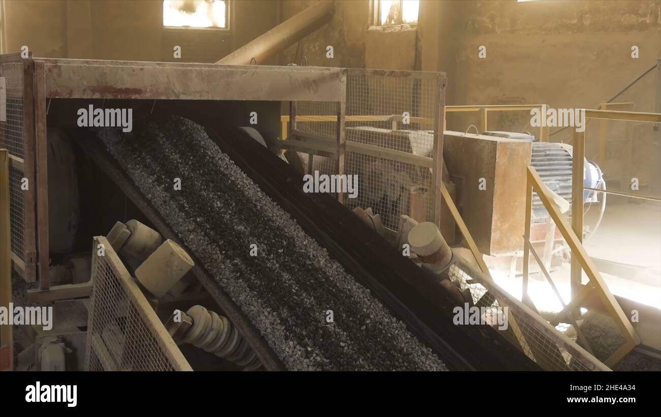 Crushed rock passing production line at mining industry. Conveyor belt ...