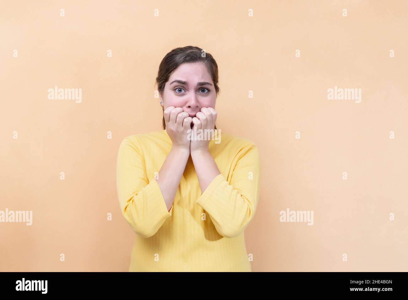 Scared young woman. Portrait of nervous girl gestures in panic ...