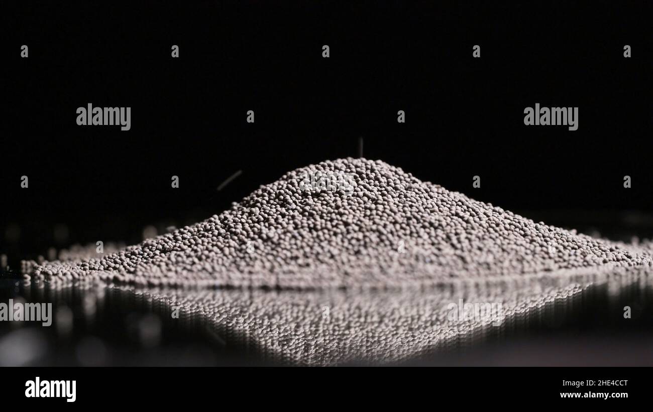 Close up of black pepper grains isolated on black background, cooking ...