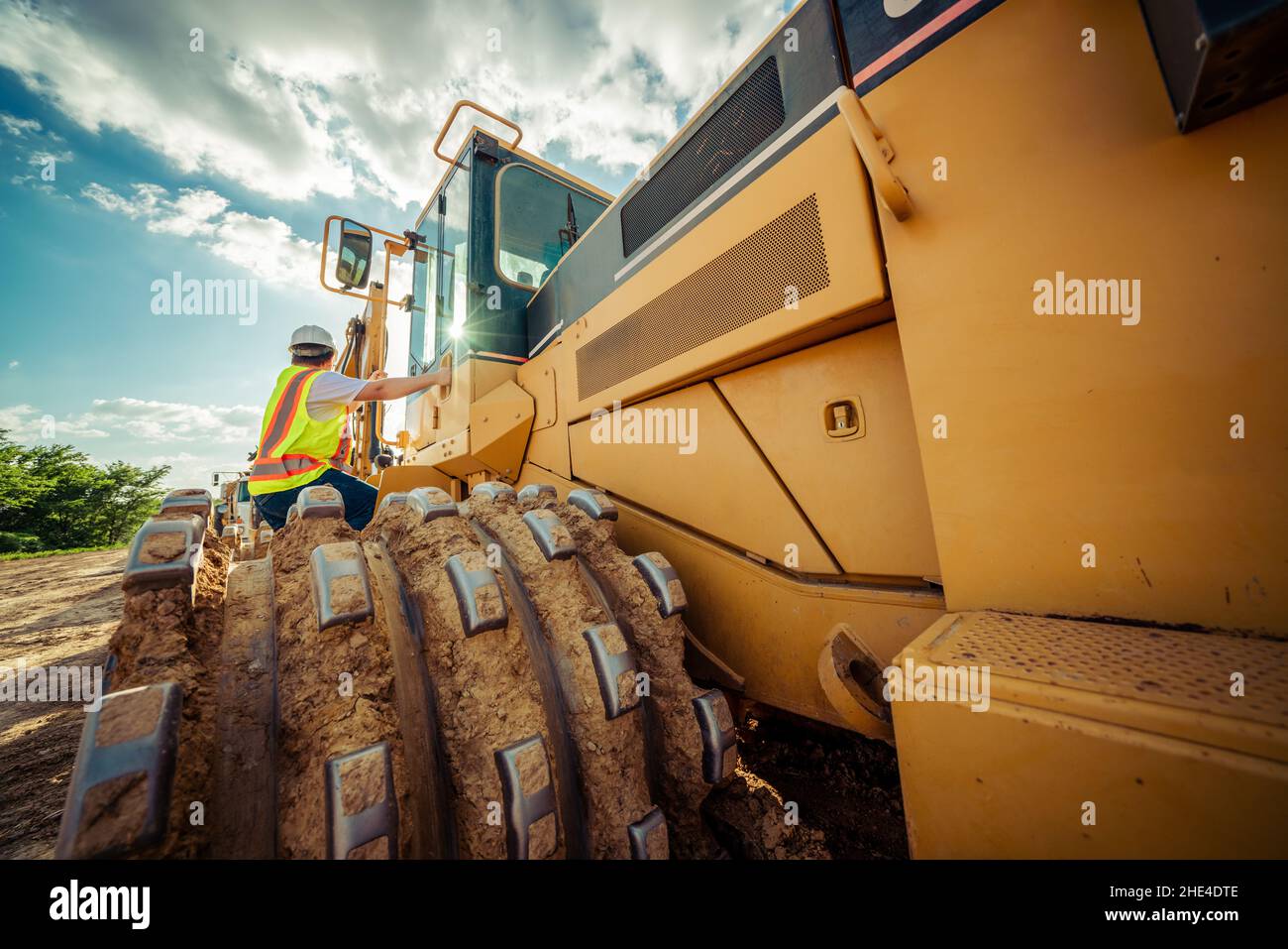 Close-up shot of workers on large earth-moving equipment Stock Photo ...