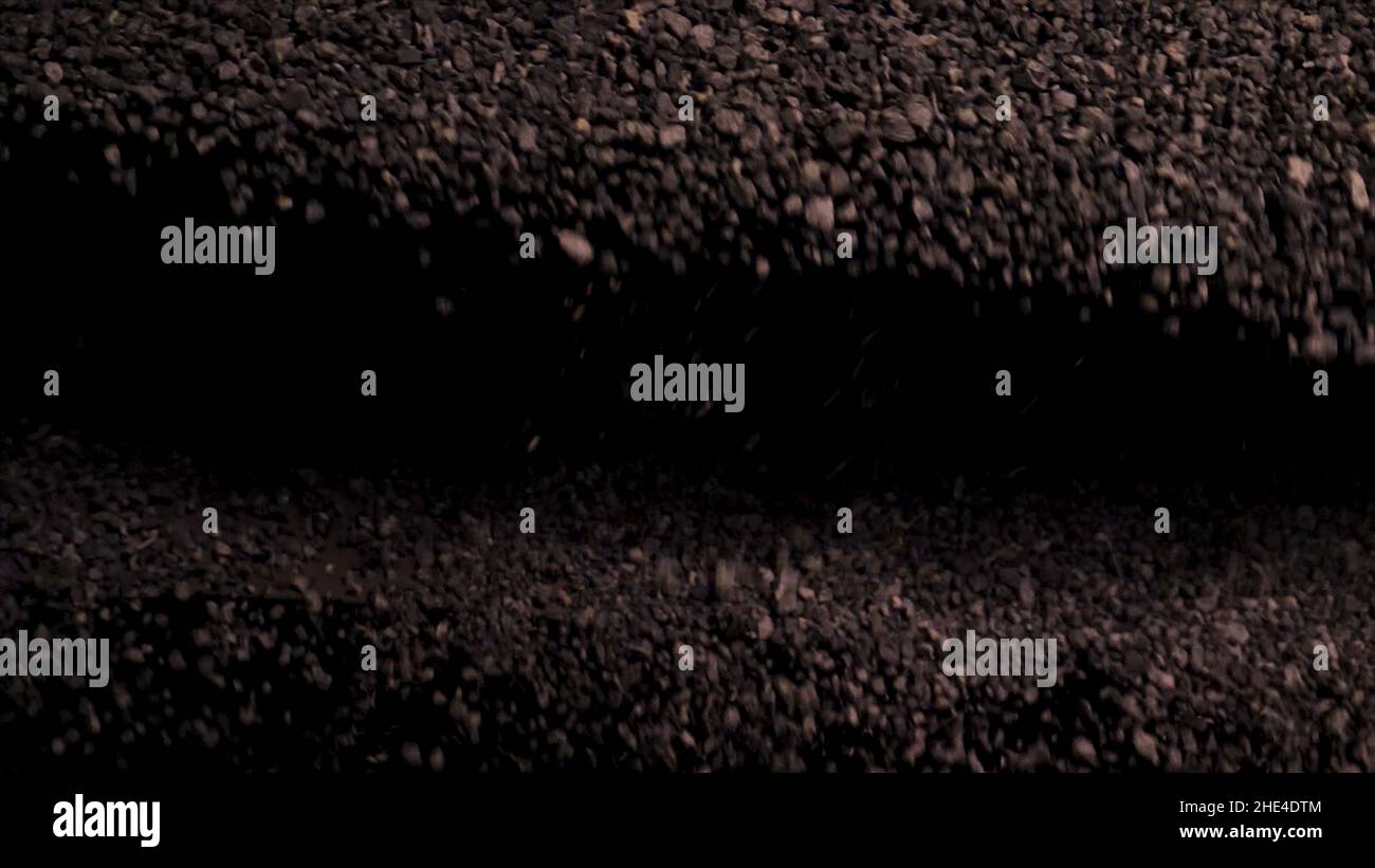 Close up process of crushed rubble falling, mining industry. Crushing ...