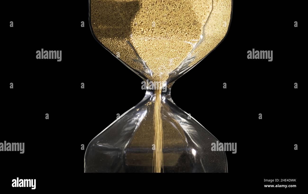 Elegant and stylish bronze transparent sandglass with trickling golden ...