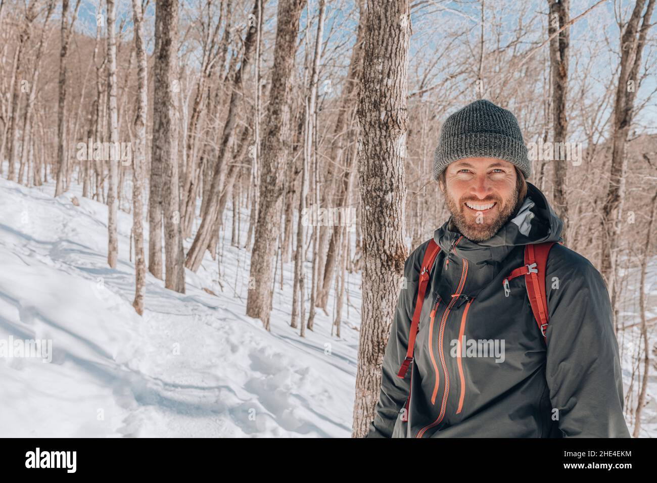 Winter hiking portrait of happy man smiling looking at camera in snow ...