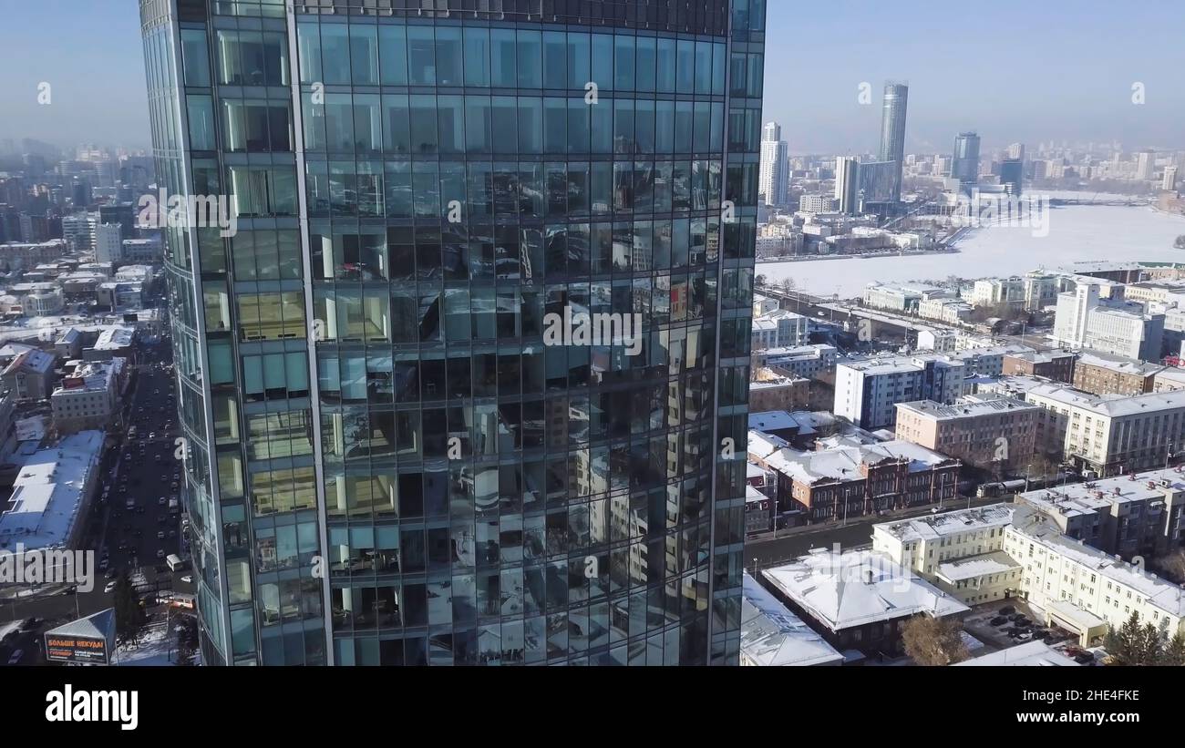 Close up of windows of modern skyscraper. Clouds refelected in modern ...