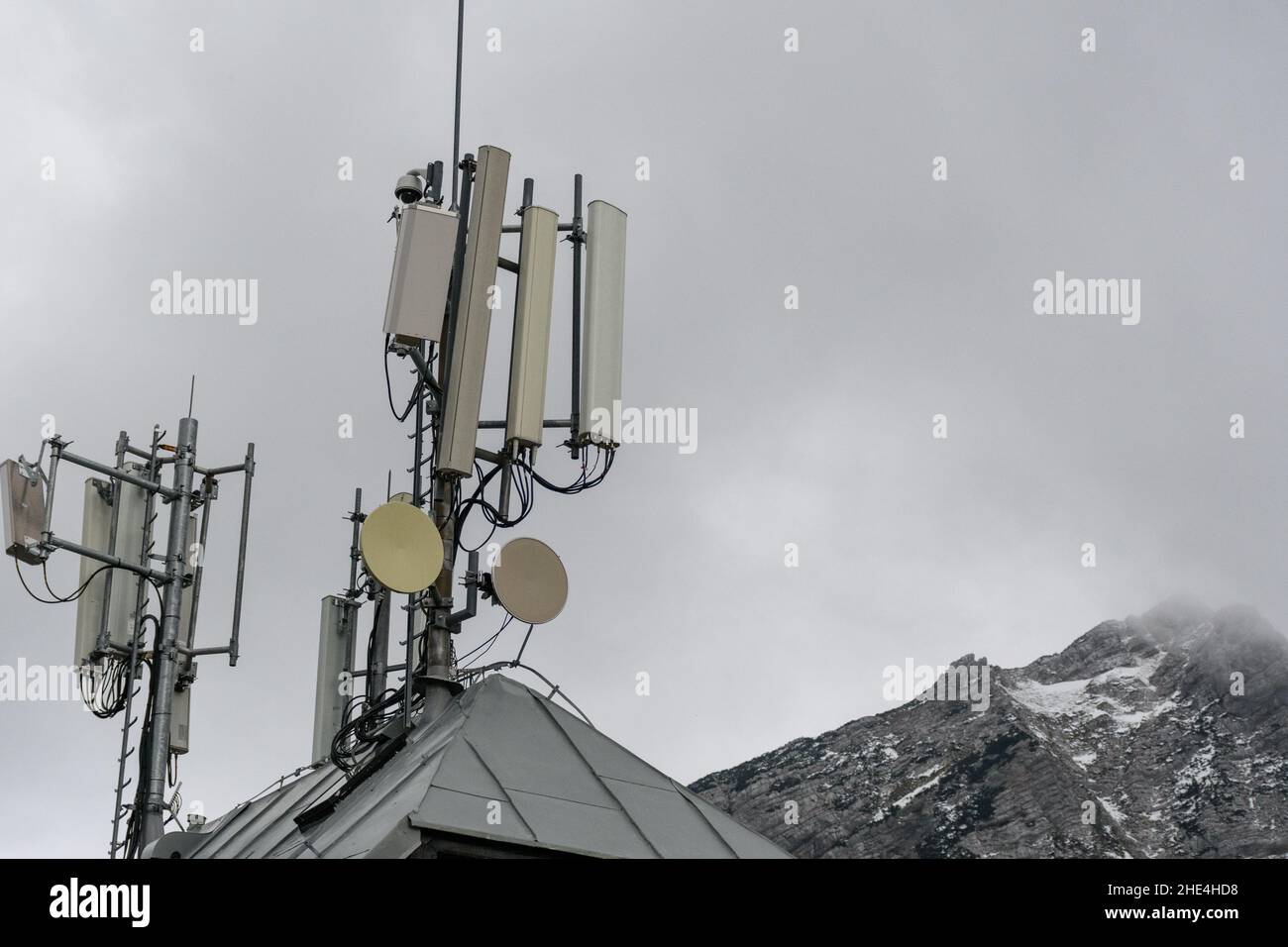 View of mobile network antennas and repeaters on the roof of a mountain ...