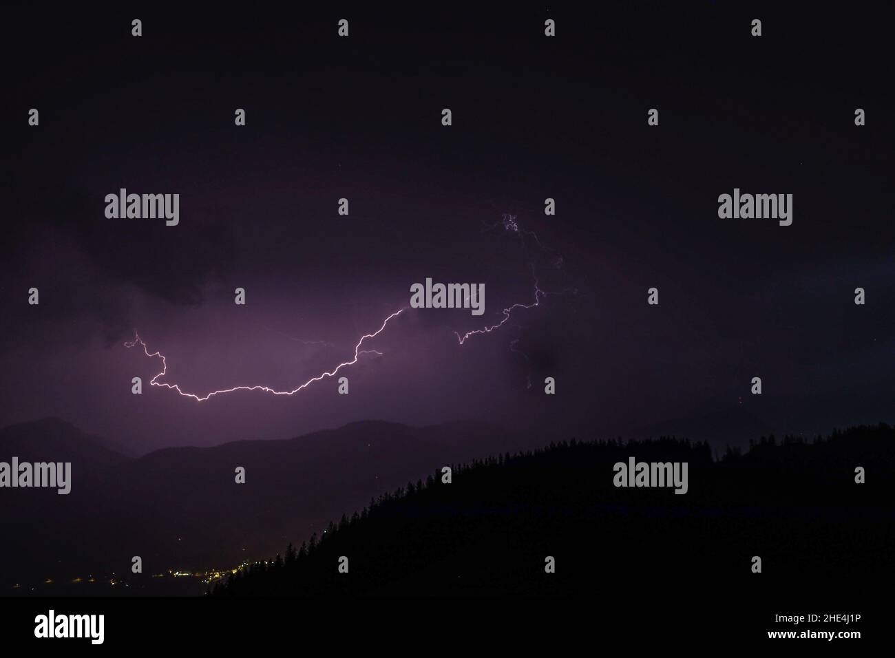 Lightning in a dark sky at a thunderstorm Stock Photo - Alamy