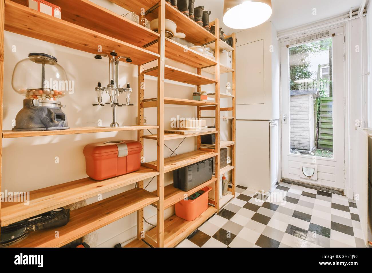 Stunning storage room with wood shelves and black and white tiled ...