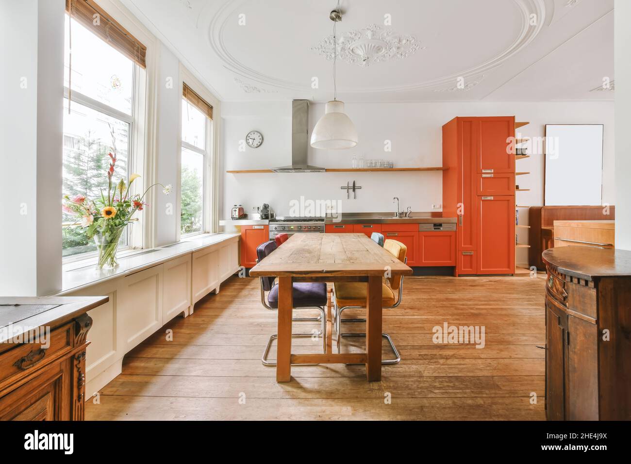 Stunning large room with table and colorful chairs and orange wardrobe ...