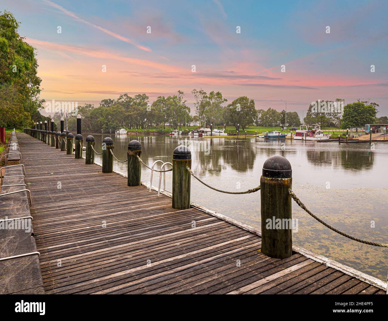 Port at dusk, water, boats, and walking path. The port of Sale, a town ...