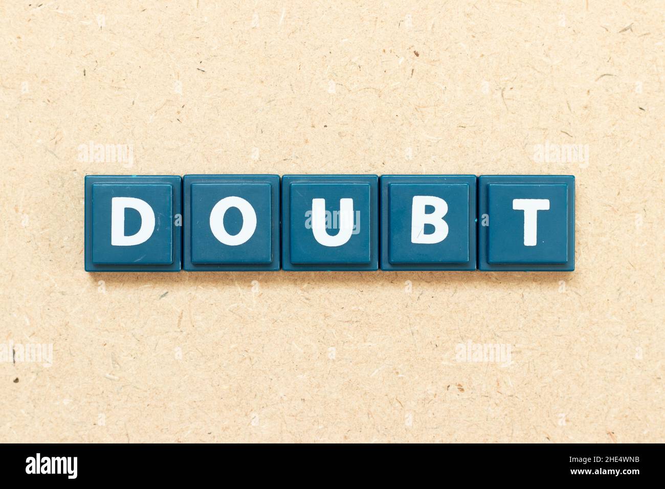 Tile alphabet letter in word doubt on wood background Stock Photo - Alamy