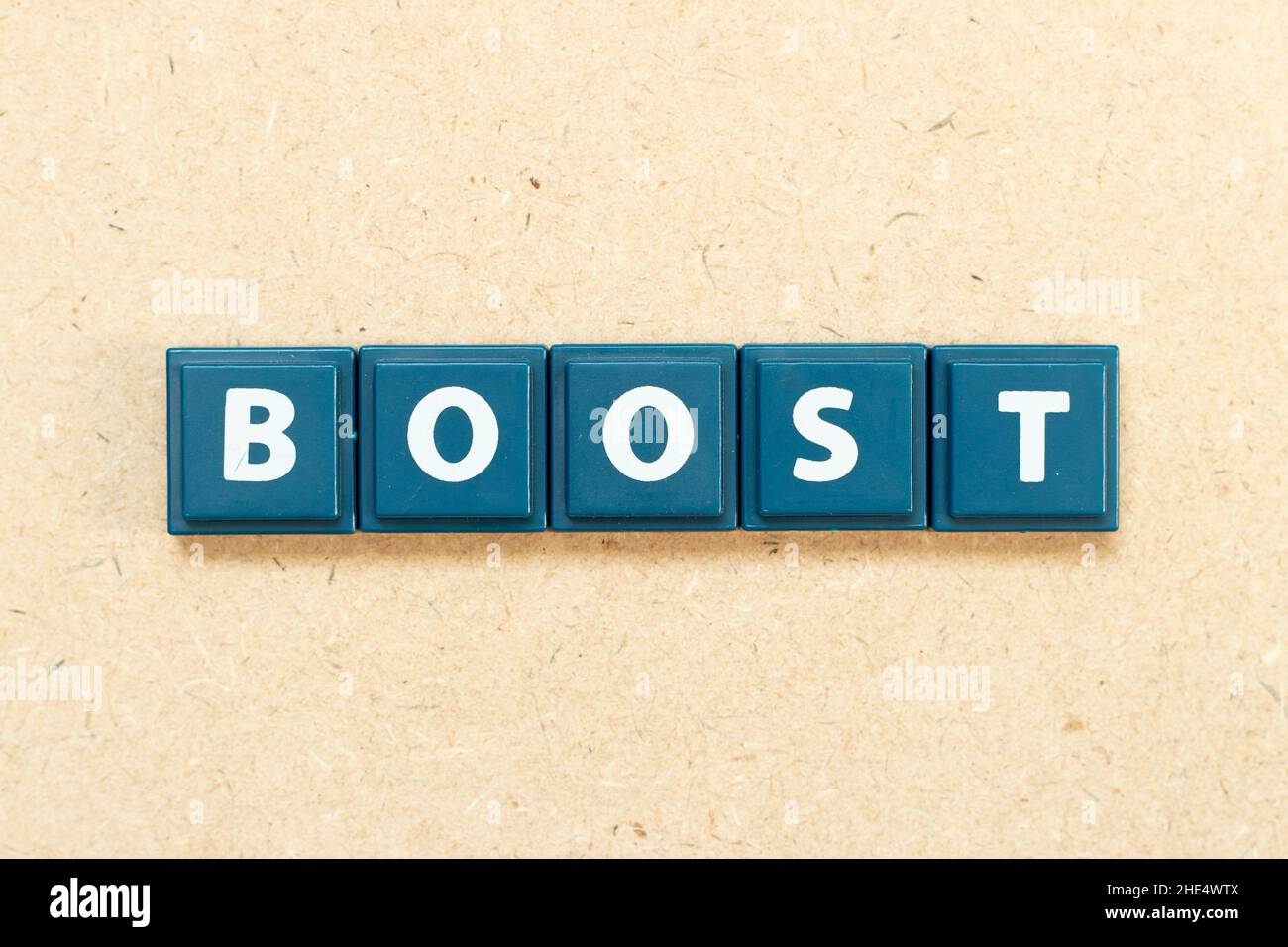 Tile alphabet letter in word boost on wood background Stock Photo - Alamy