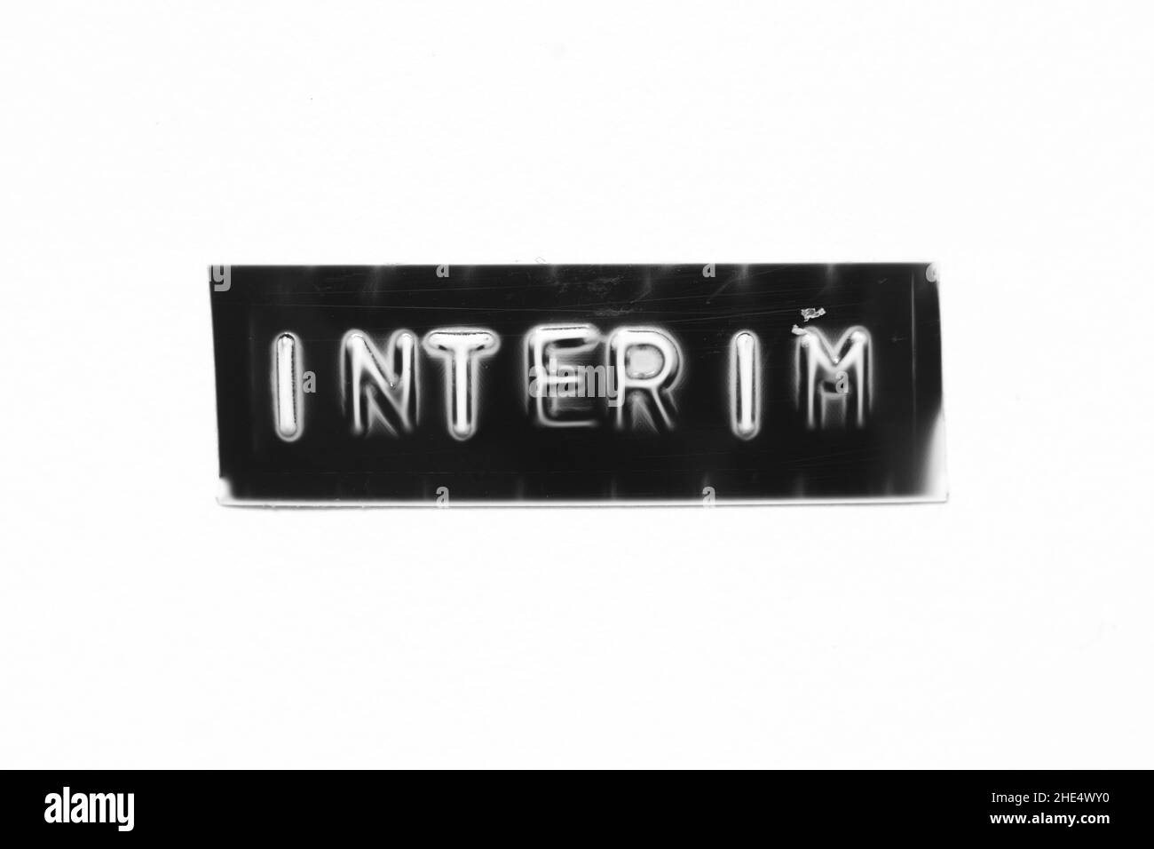 Black color banner that have embossed letter with word interim on white ...