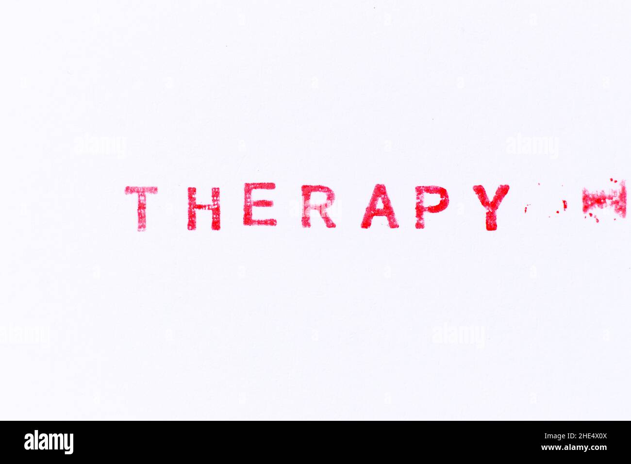 Red color ink rubber stamp in word therapy on white paper background ...