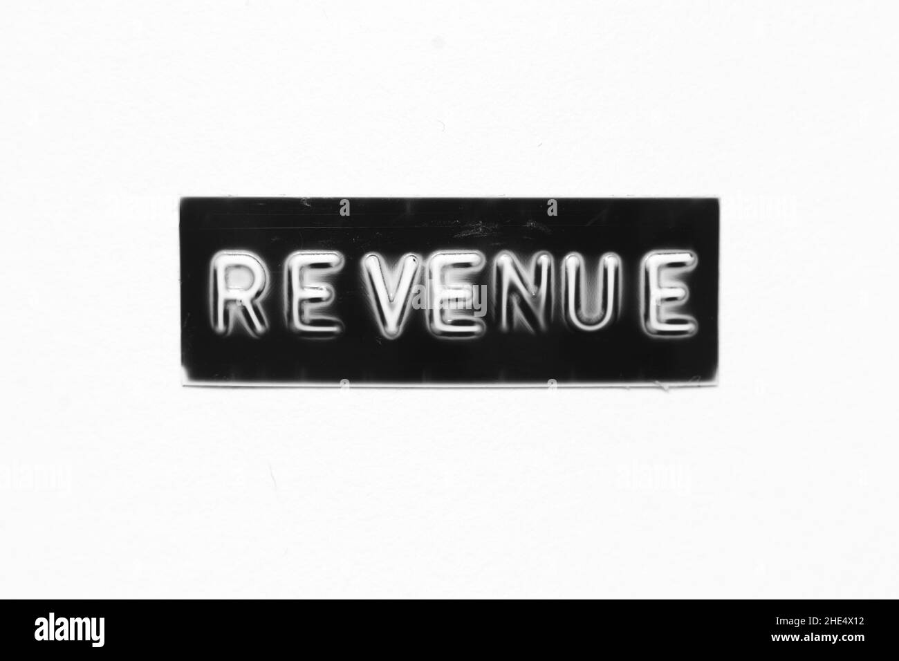 Black color banner that have embossed letter with word revenue on white ...