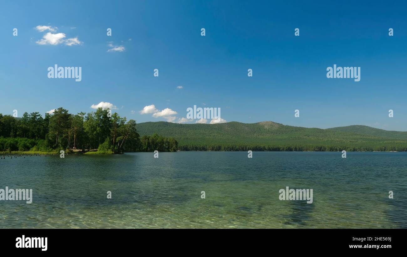 Beautiful lake view. Summer landscape with blue sky, trees and lake ...