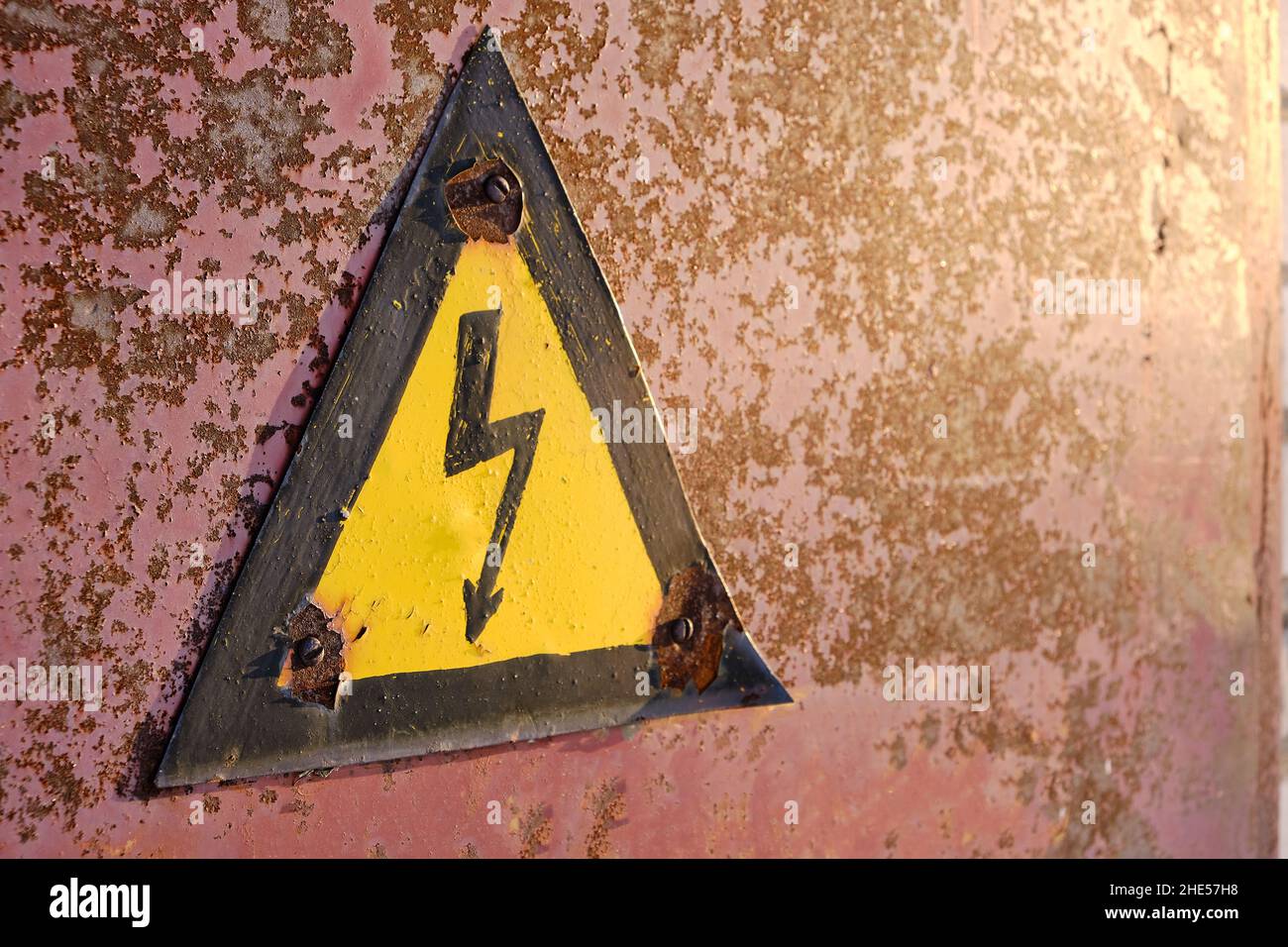 Old, rusty warning about danger and high voltage in form lightning ...