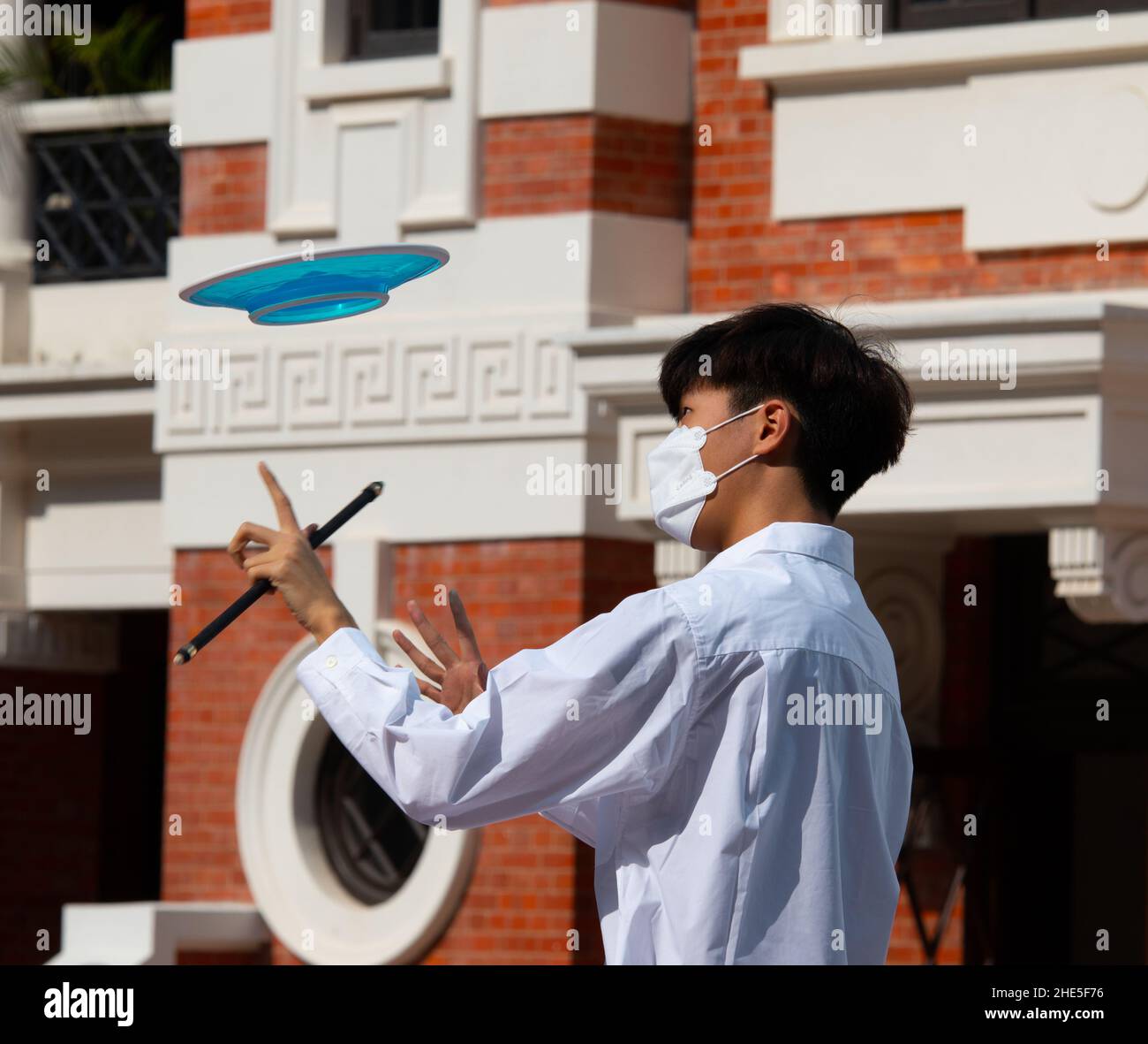 Teenage boys practice spinning and juggling plates for a public ...