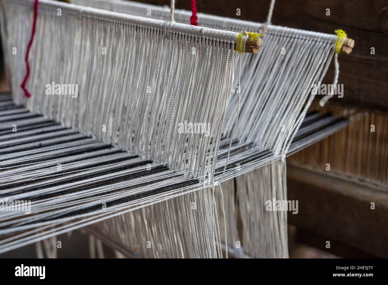 Old hand-weaving vintage wooden loom being used to make fabric, close ...