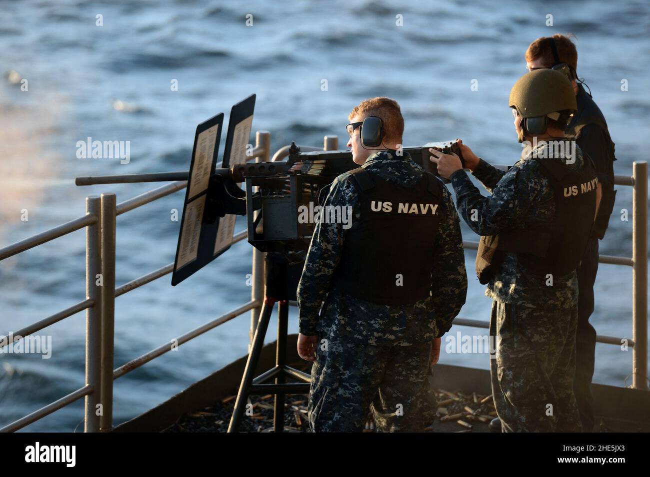 Sailor fires a .50-caliber machine gun at sea. (8382938769 Stock Photo ...