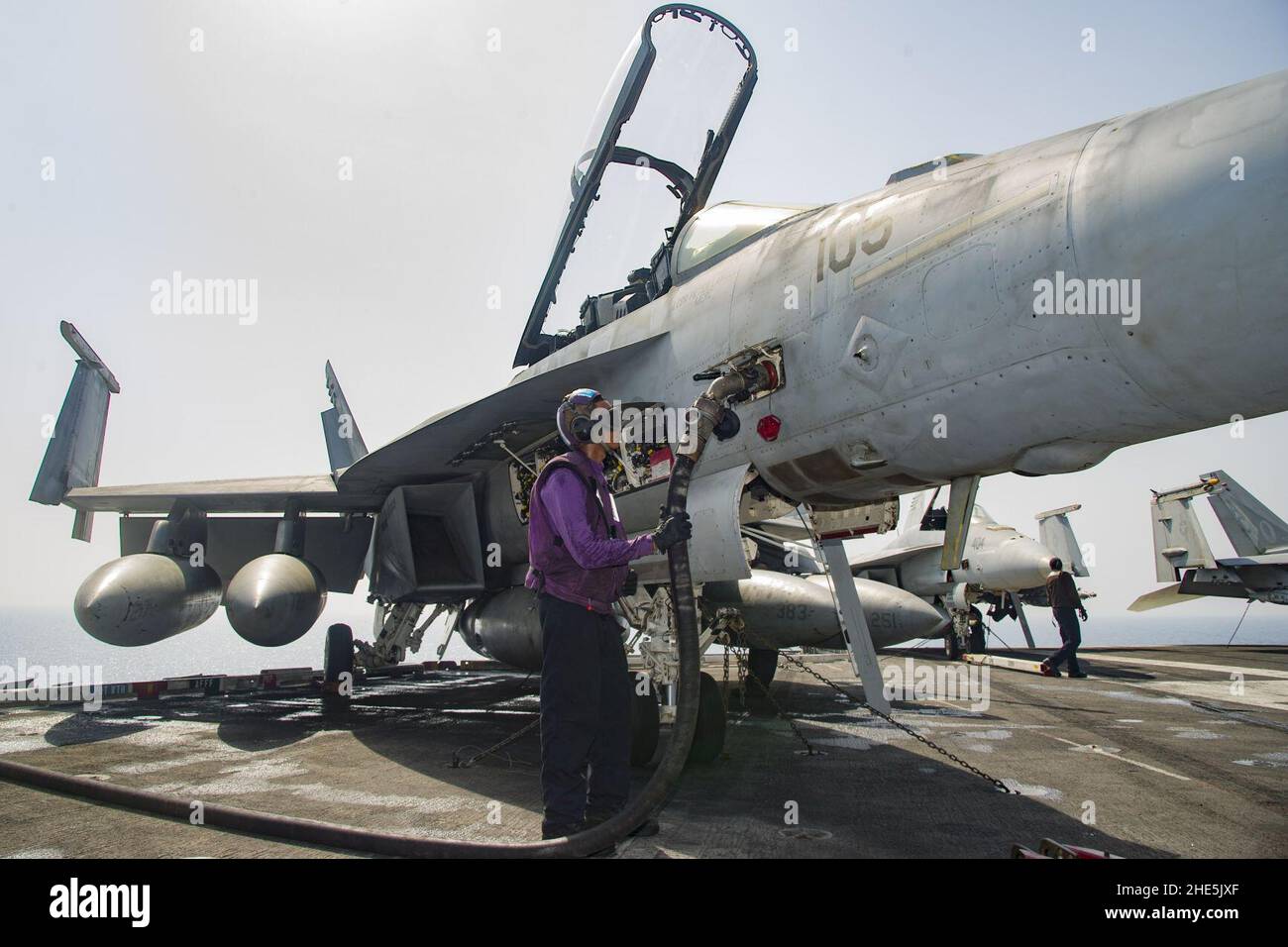 Sailor fuels an F-A-18F Super Hornet on the flight deck of USS Dwight D ...