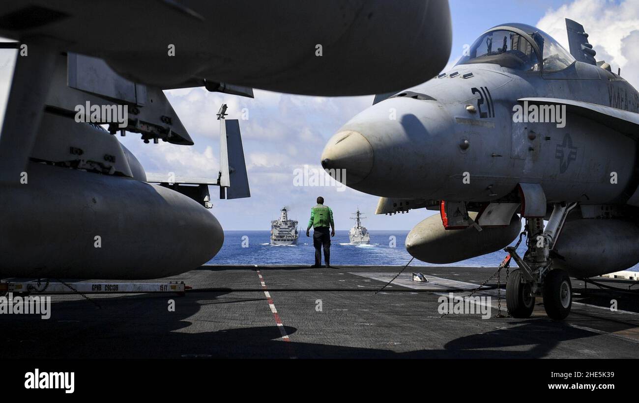 Sailor observes a refueling-at-sea between USNS Guadalupe and USS ...