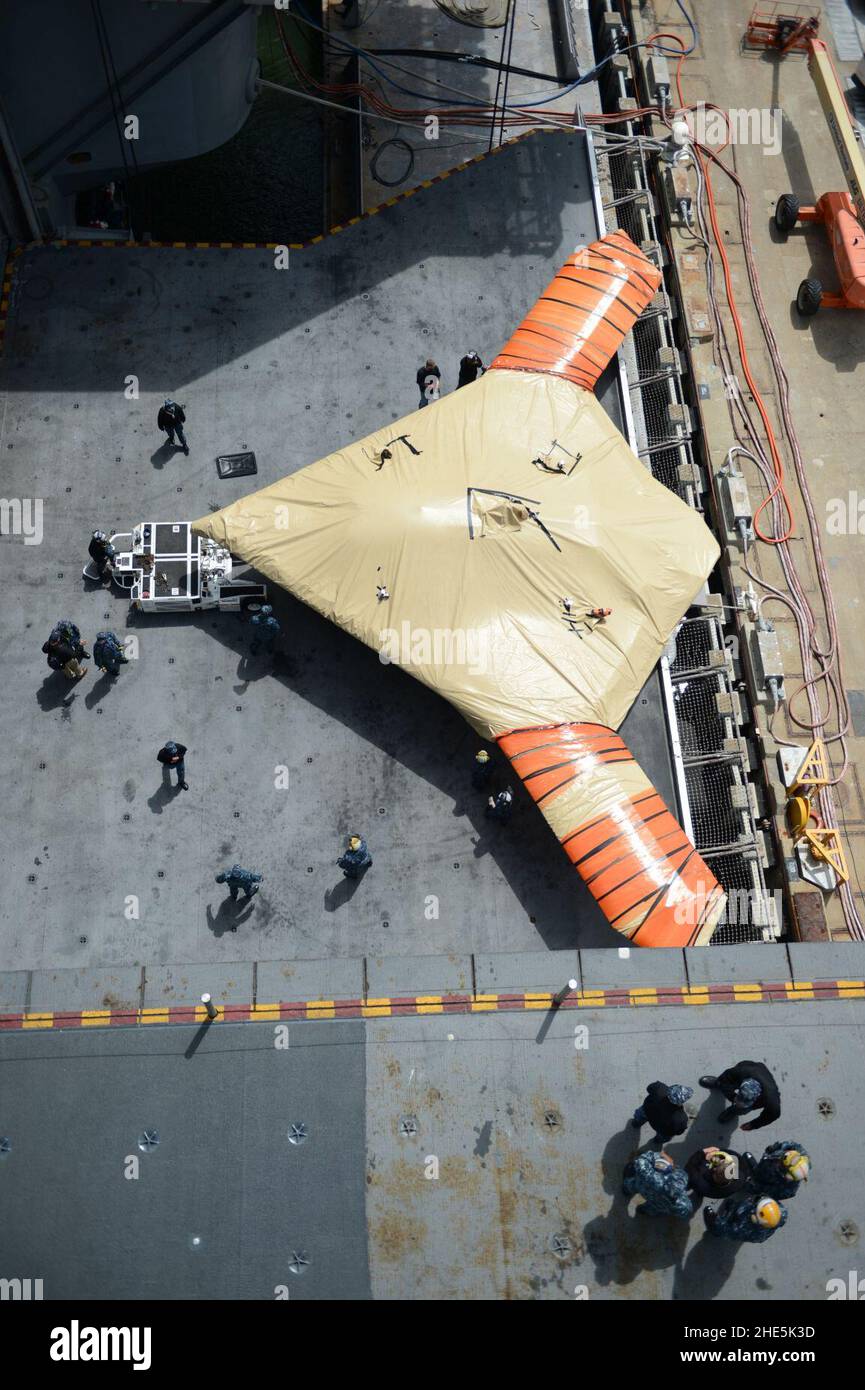 Sailor moves an X-47B from an aircraft elevator aboard USS George H.W ...