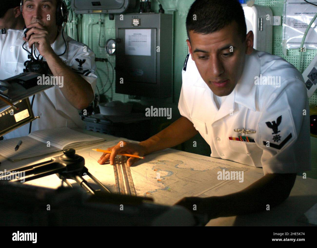 Sailor Plots course aboard USS San Antonio Stock Photo - Alamy
