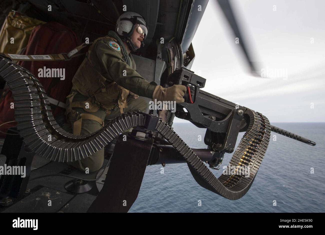 Sailor prepares to shoot a target with a .50 caliber machine gun during ...