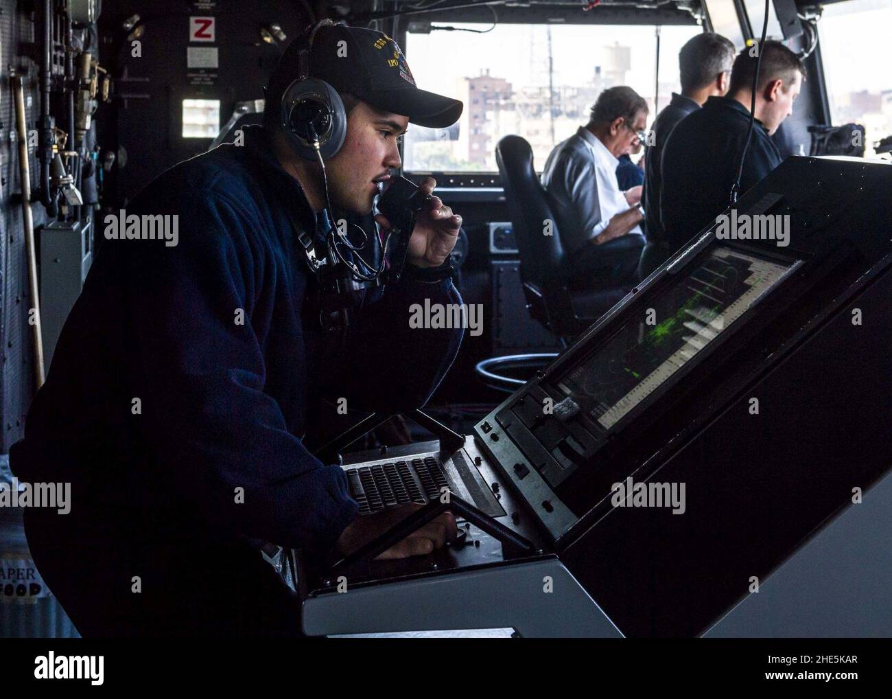 Sailor standing radar operator watch aboard USS Anchorage (LPD-23 ...