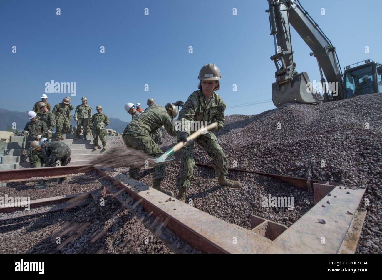 Sailor shovels aggregate with Republic of Korea (ROK) Seabees during ...