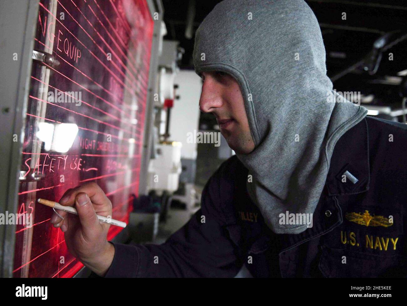 Sailor updates ship's status during a general quarters drill aboard USS ...