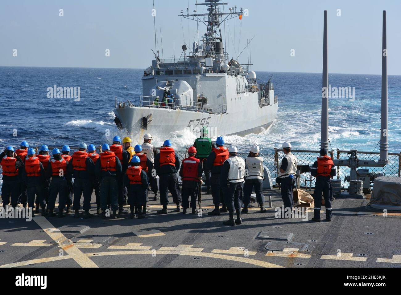 Sailors aboard USS Cole watch the French military dispatch vessel ...