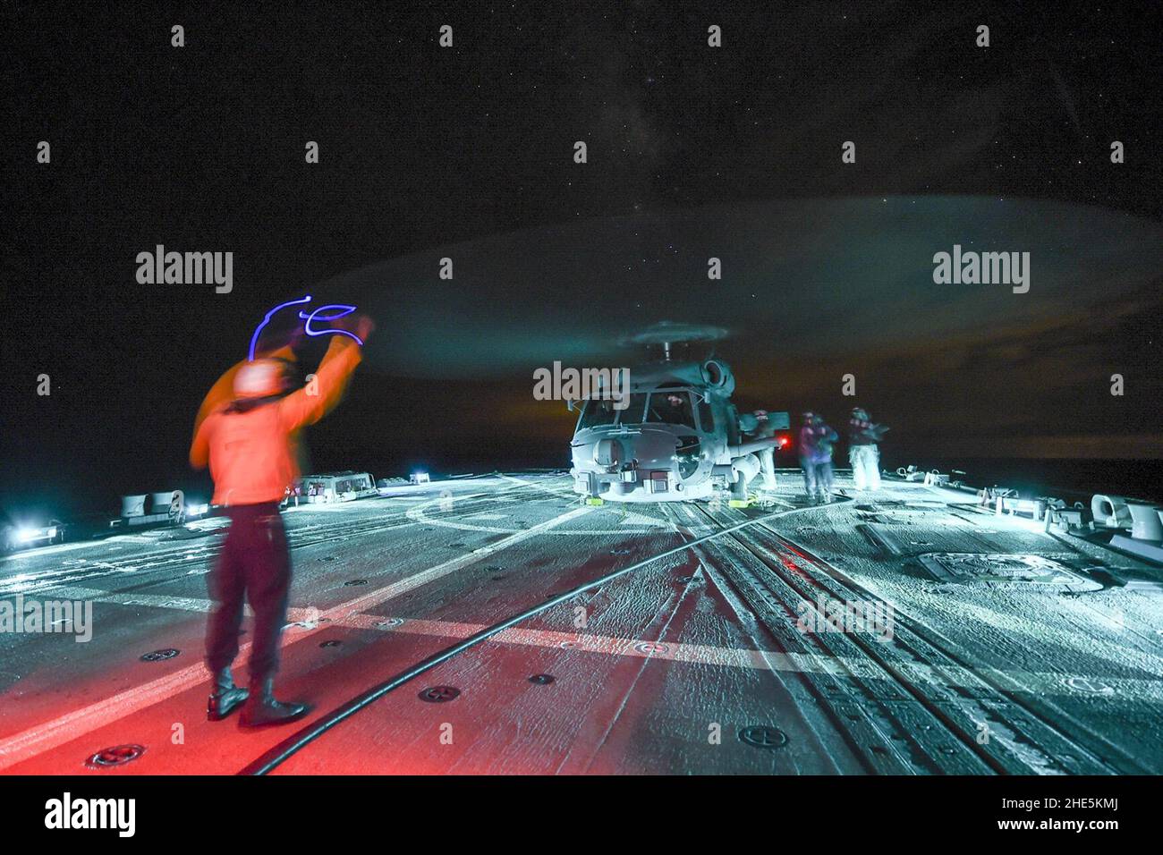 Sailors aboard USS Gravely (DDG-107) refueling an MH-60R Sea Hawk ...