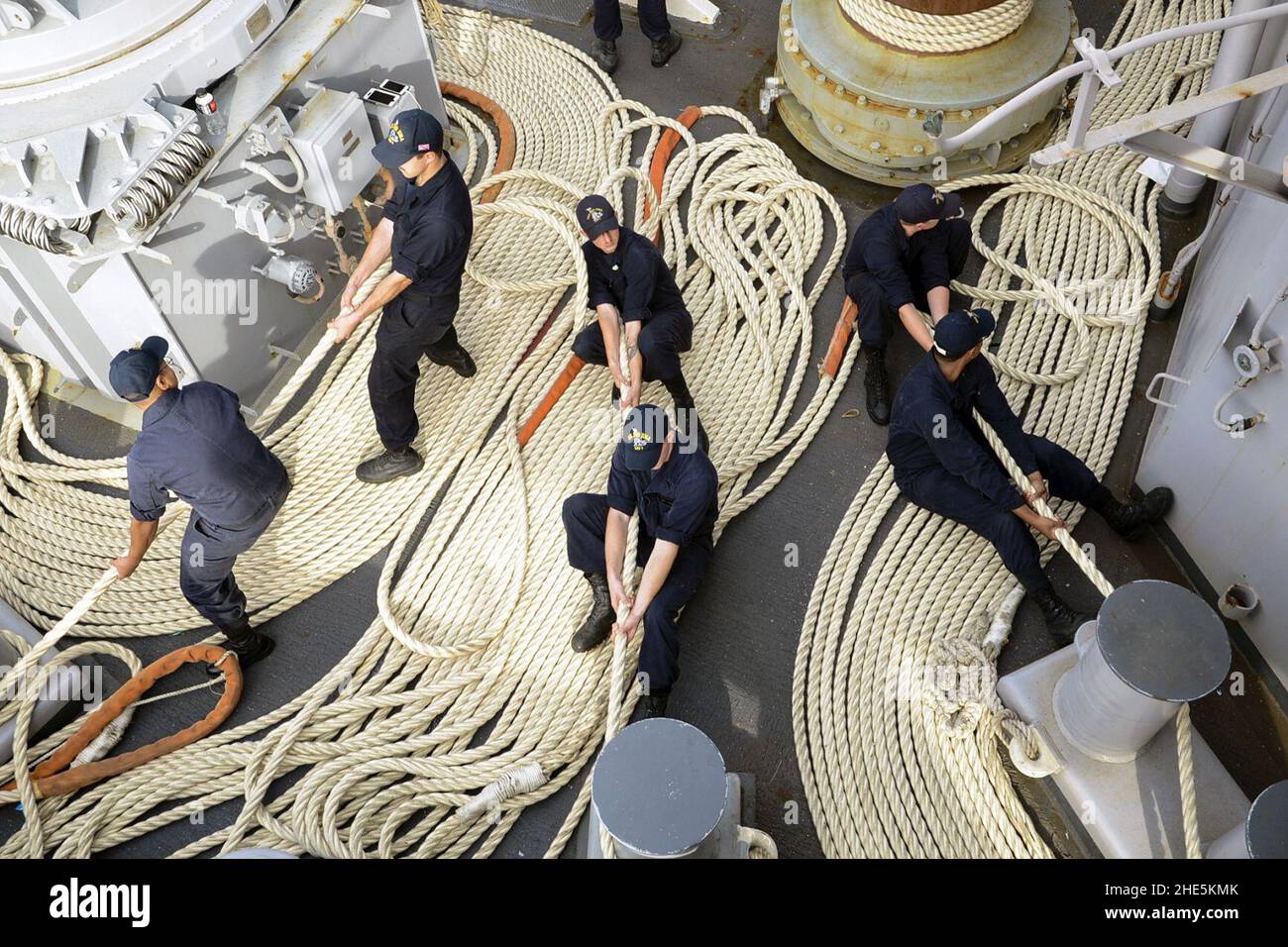 Sailors aboard USS Iwo Jima heave mooring lines during a sea-and-anchor detail. (30386553420 ...
